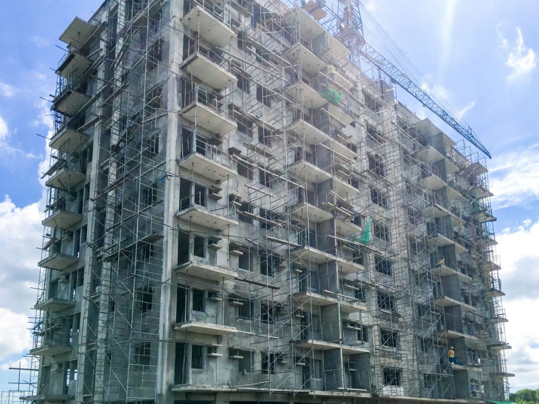 View of the front and left elevation with plastered exterior walls.