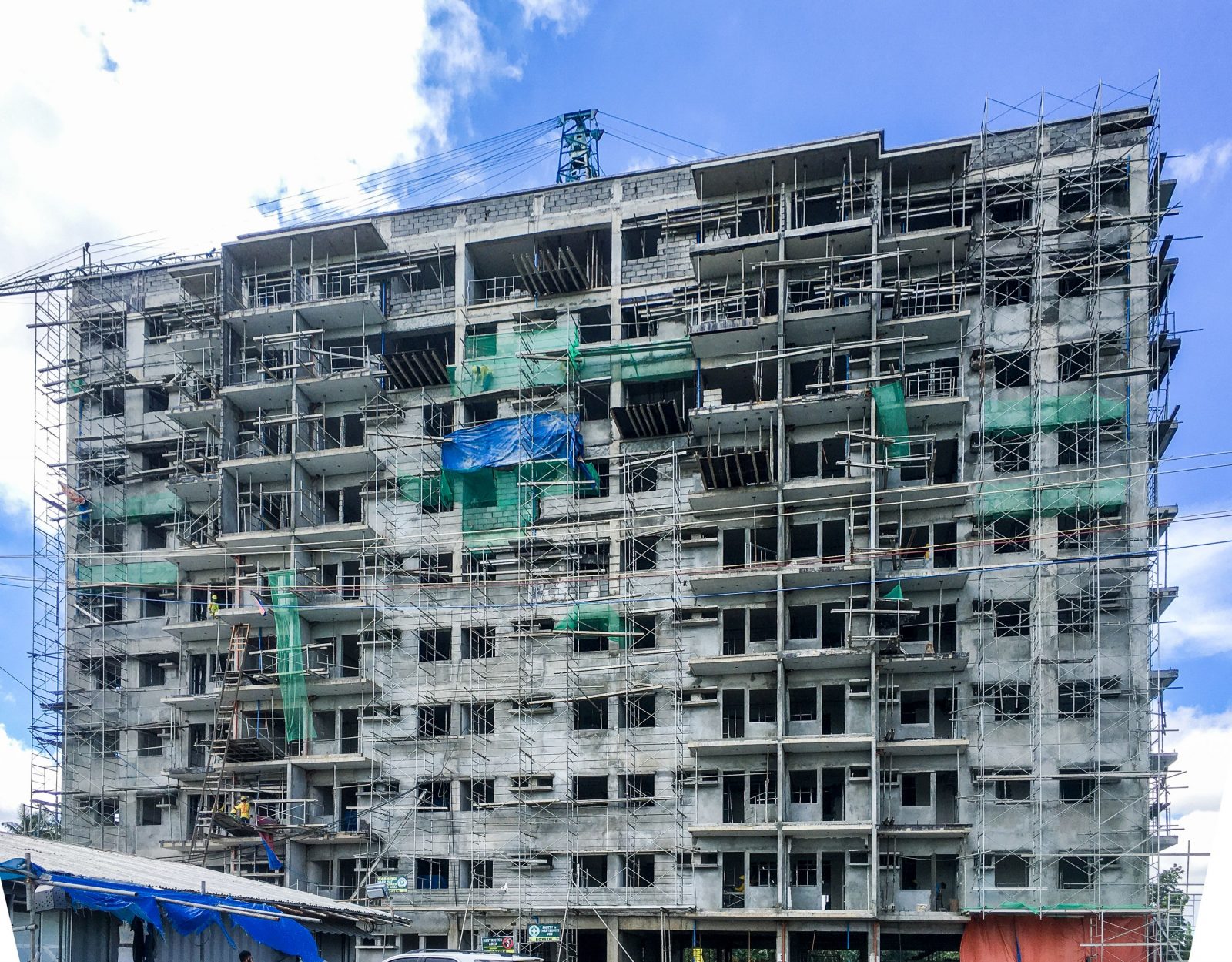 Rear side view of Brenham building with on-going masonry works at the ...